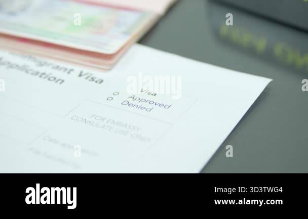 Close up putting stamp approved into visa application paper . High ...