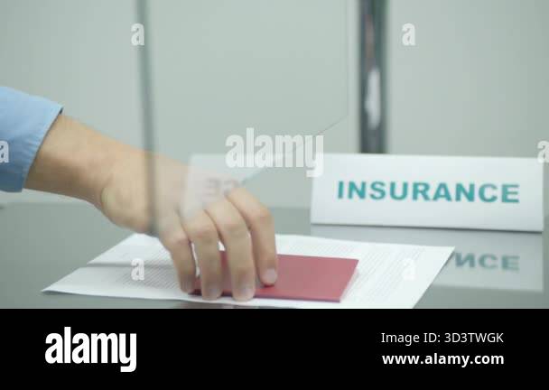 Insurer checking passport and stamping insurance agreement . High ...