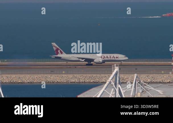 HONG KONG - JANUARY 28, 2025: Shot of Qatar Cargo Boeing 777 landing ...