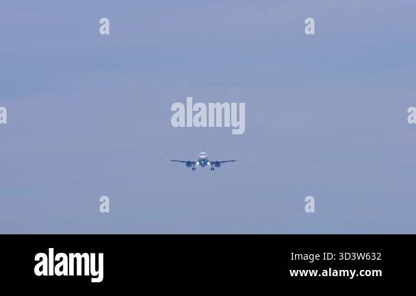 Shot of a jet plane with its lights on approaching for landing ...
