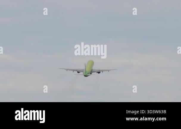 Passenger jet airplane taking off and climbing into the sky. Rear view ...