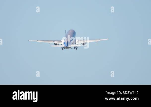 Rear view of a jet airliner with generic livery departing the runway ...
