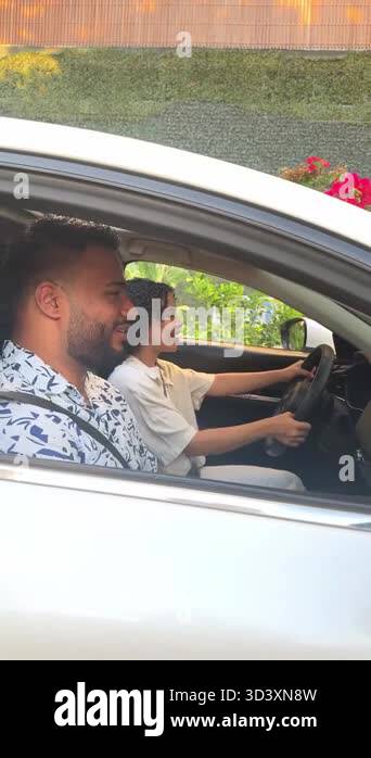 Young woman learning to drive a car with her father as an instructor in ...