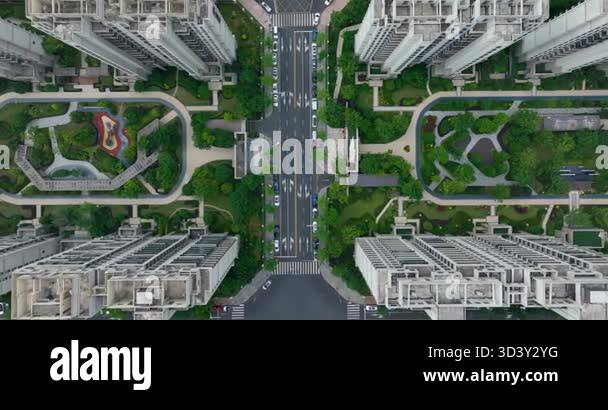 Straight-down aerial view of a symmetrical residential street bordered ...