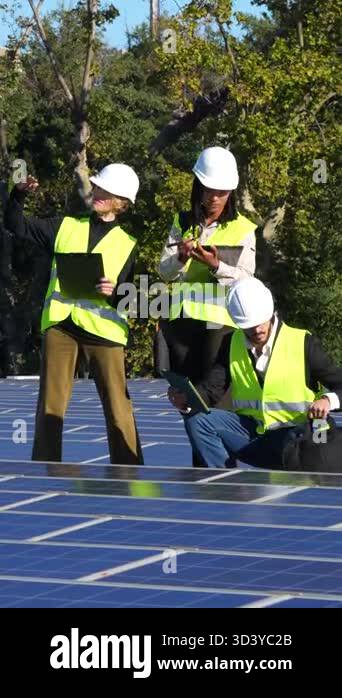 Diverse group of three professional engineers in hard hats and safety ...