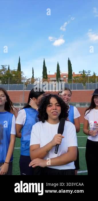 Young female reporter with a microphone conducting a lively interview ...