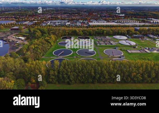 Aerial view reveals a modern wastewater treatment facility surrounded ...