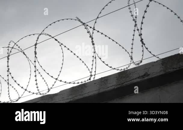 Barbed wire against the sky. Refugee camp Stock Video Footage - Alamy
