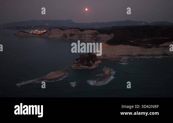High-angle aerial view of a full moon illuminating the Ionian sea ...