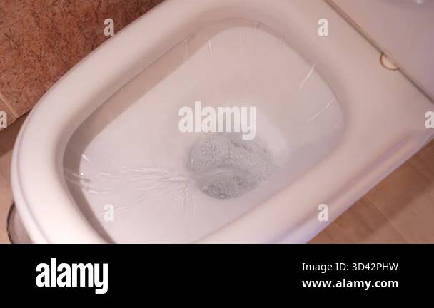A series of images showcasing the toilet flush process, depicting water ...