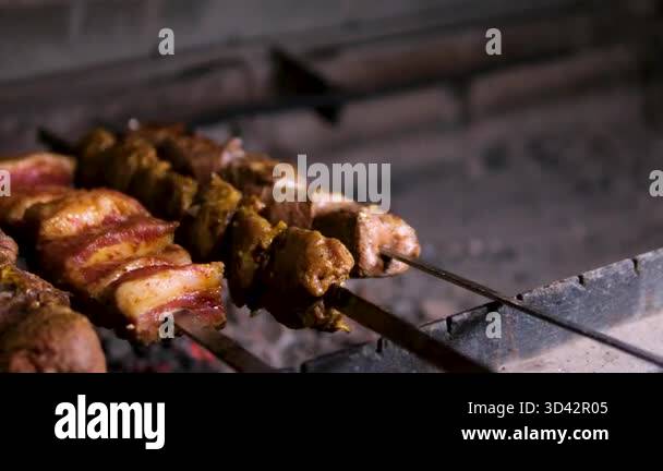 Grilling shashlik kebab on barbecue grill outdoors. Preparing juicy ...