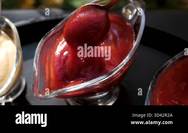 Tasty spicy barbecue sauce texture smearing with a spoon close up. High ...