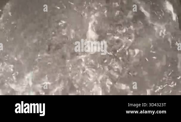 boiling water texture closeup on electric stove, food closeup top view ...