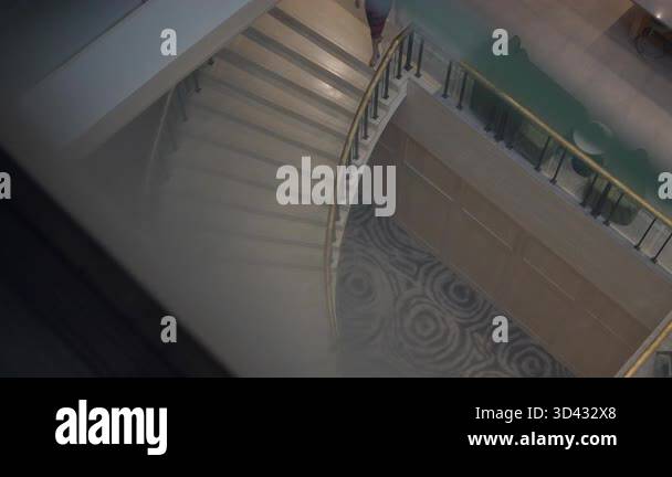 woman climbs spiral staircase gracefully, an elegant lady ascends ...