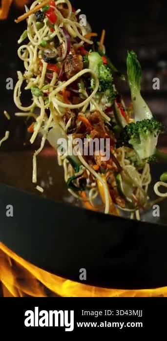 Super Slow Motion of Flying Asian Wok Ingredients . Filmed on High ...