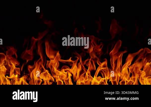 Super slow motion of fire flames isolated on black background. Filmed ...