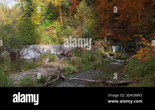 Beautiful autumn waterfall in a colorful forest. Scenic natural ...
