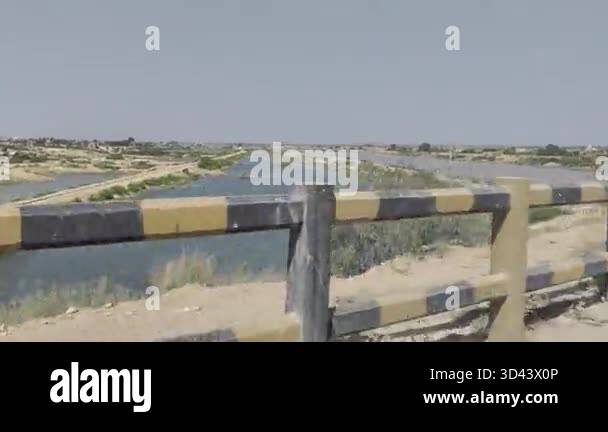 Crossing Over: Bridge View of Canal Water and Arid Landscape Stock ...