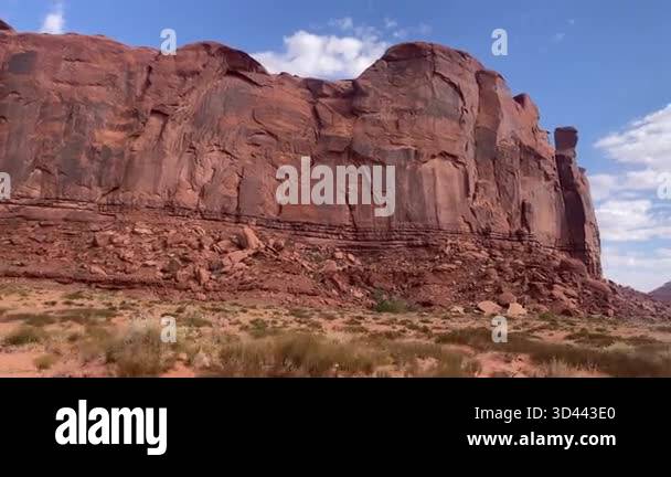 Majestic sandstone formations rise from the desert ground, surrounded ...