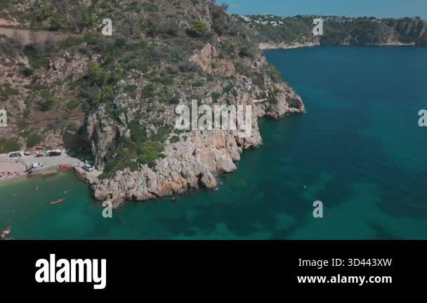 Aerial view of the rocky cliffs and blue Mediterranean Sea near Cala ...