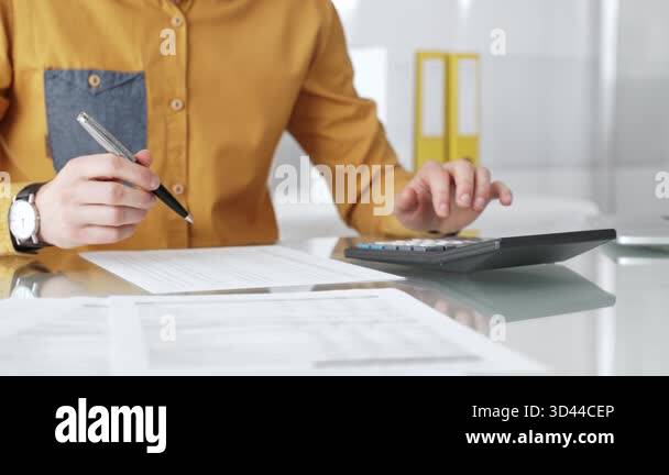 Person reviewing financial spreadsheets and receipts, calculating ...