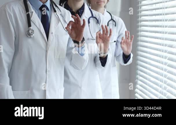 Medical team of healthcare workers and doctors in white lab coats and ...