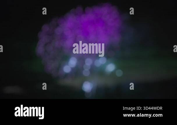 Colorful fireworks lighting up the night sky in an abstract blurry background. Slow motion Stock ...