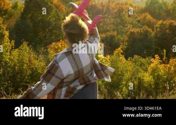 Scene captures child twirling excitedly, red glider tracing wide circle ...