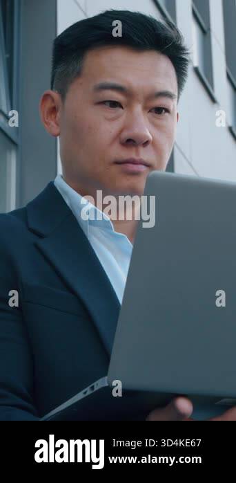 Asian business man Korean middle-aged businessman with laptop in city ...