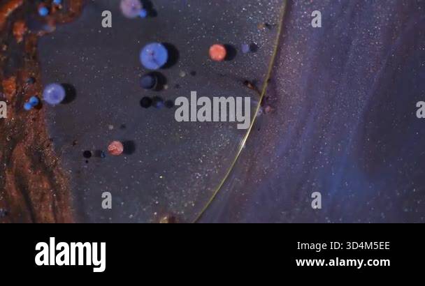 Ink spill. Glitter liquid. Defocused orange blue purple color oil round ...