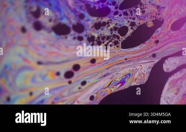 Vertical video. Art gasoline. Fluorescent paint. Defocused neon purple ...