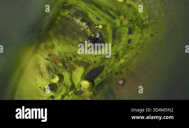 Ink stream. Acrylic bubbles. Defocused yellow green purple color oil ...