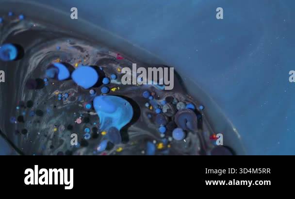 Spill bubbles. Oil blend. Defocused blue purple red colorful glitter ...