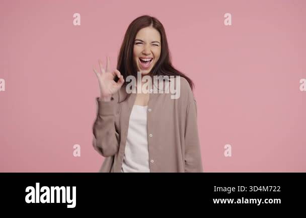 Gorgeous american woman showing yes signal, nods head, approve ...