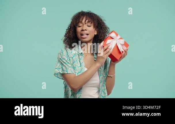 Happy stylish african american woman gift box on Blue background. Lady ...