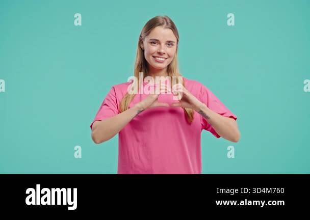 Pretty woman forms heart shape with hands, sending love. Charming lady ...