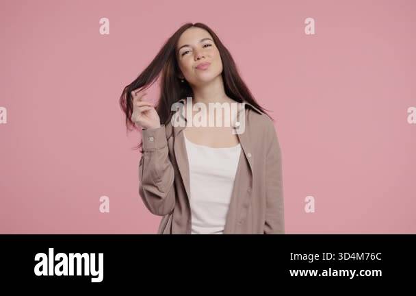 Playful Brunette Woman Smiling, Flirting To Camera On pink Studio ...