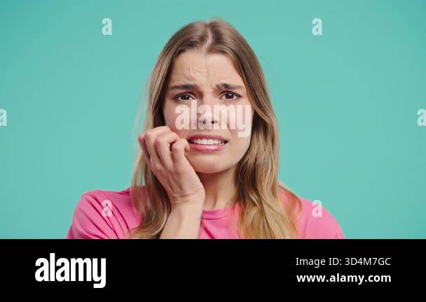 Concerned blonde woman showing signs of stress. Body language convey ...