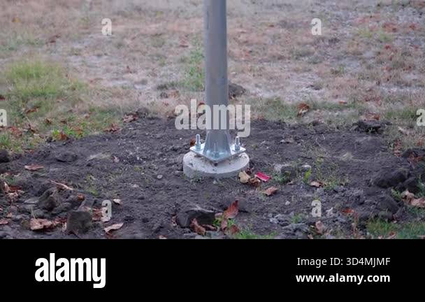 Metal pole installation sequence captures the gradual securing of the ...