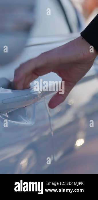 Close-up of a mans hand using a smartphone app to remotely control his ...