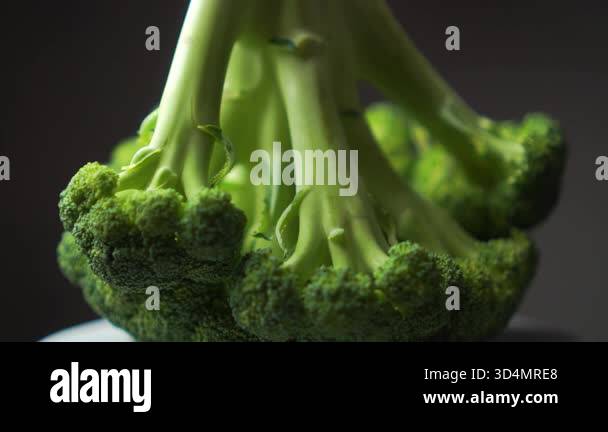 A cinematic rotating video of fresh broccoli in macro close-up on a ...
