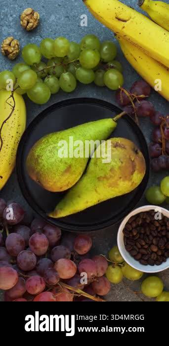 A vertical top down loop rotates a brown plate with pears surrounded by ...