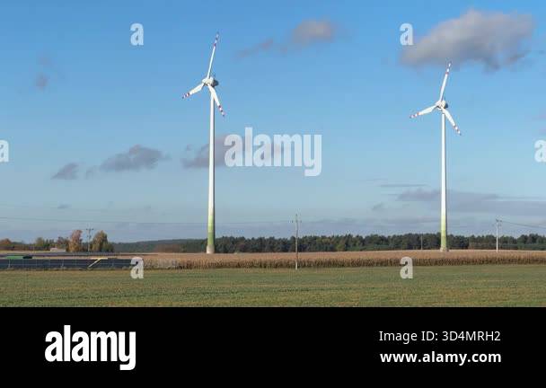 A cinematic hero shot panning video of wind turbines moving from left ...