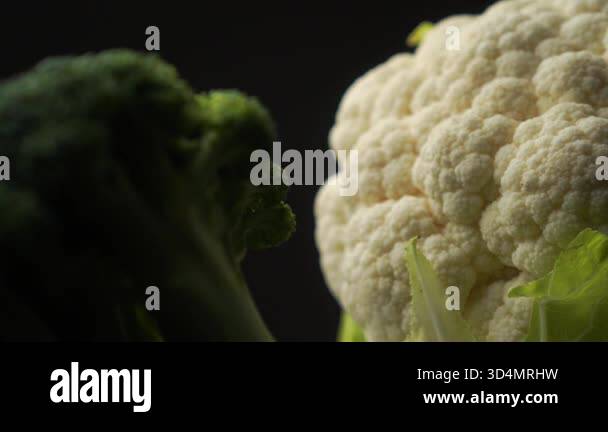A detailed macro video of broccoli and cauliflower rotating under soft ...
