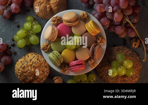 A smooth loop shows a rotating white plate of macarons surrounded by ...