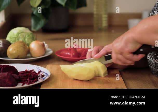 Cutting Peeled Potato Into Pieces For Ukrainian Borscht Chopping Tuber
