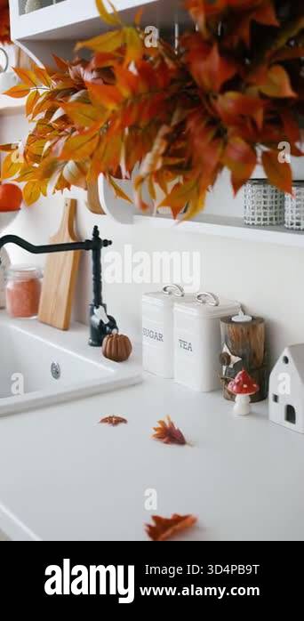 Autumn leaves and pumpkin on kitchen counter with sugar and tea ...
