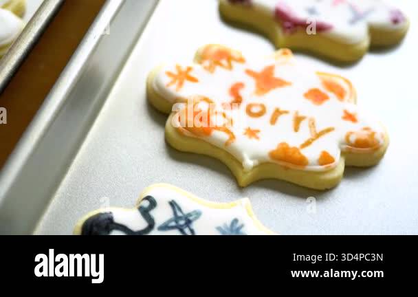 A heartwarming scene of a little girl carefully writing Sorry on sugar ...