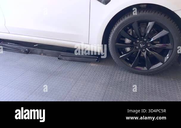 Castle Rock, CO, USA-October 12, 2025 - Slow Motion - A white Tesla car ...