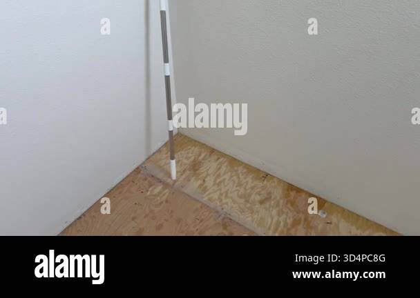 Edge of a white wall with a plastic paint guard tool clipped in place ...